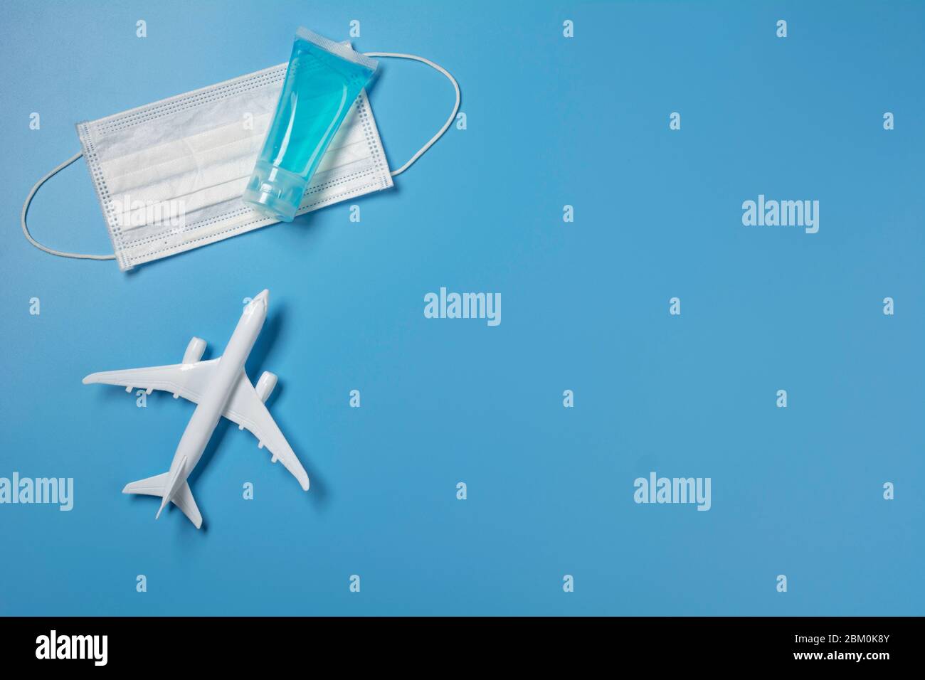A toy airplane with medical mask for protecting virus and dust. Travel ...