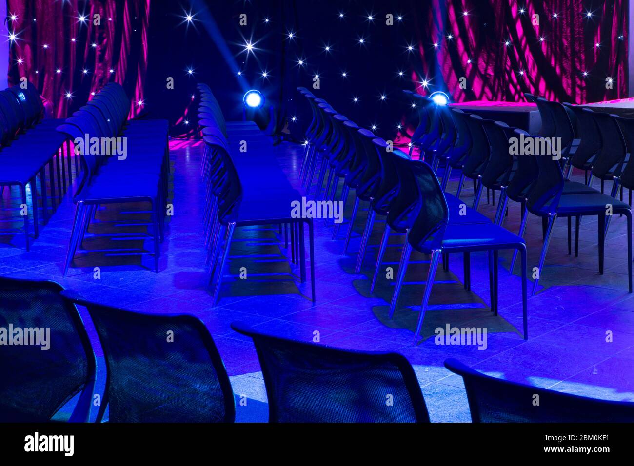 Congress hall with blue chairs organised in rows Stock Photo - Alamy