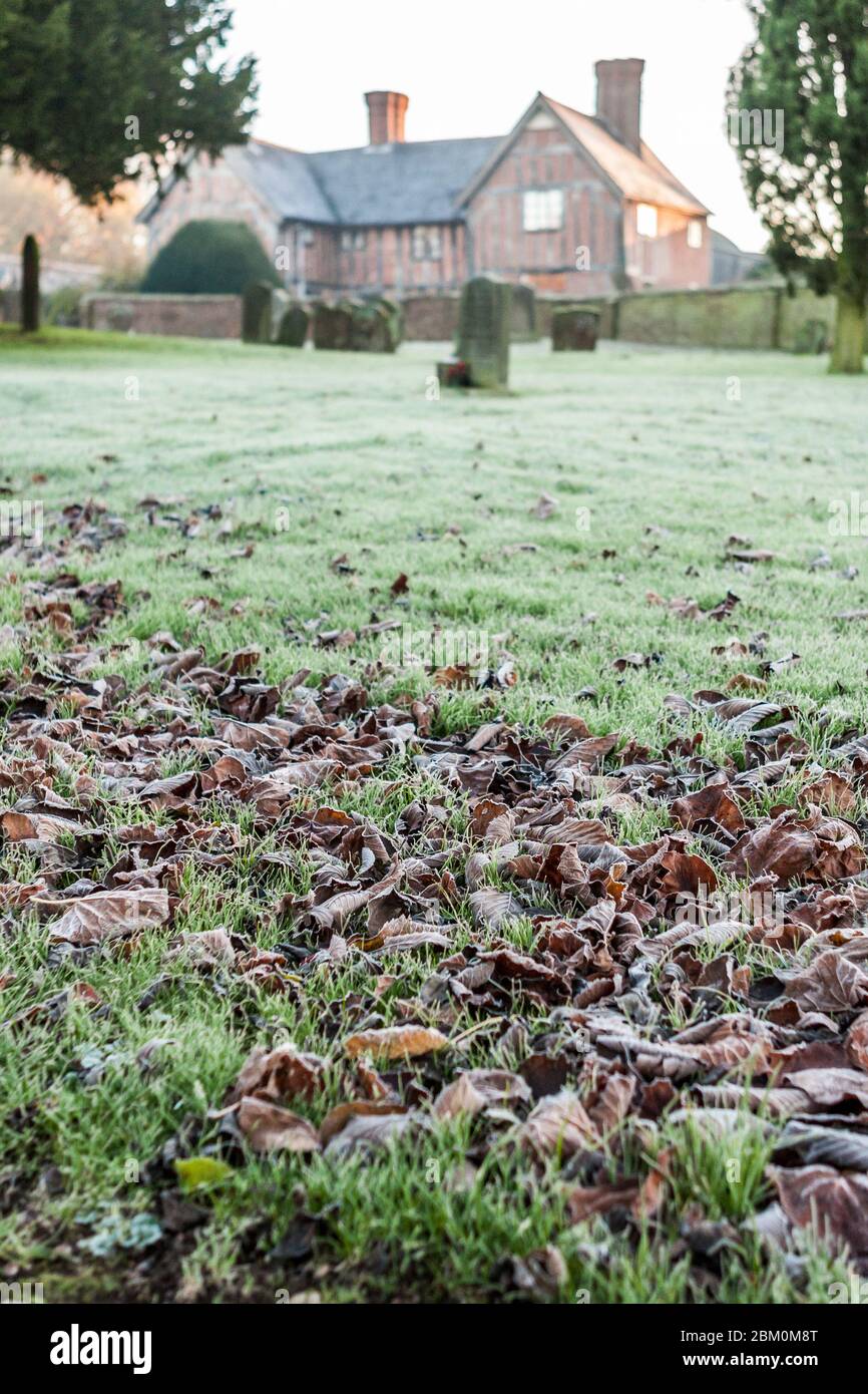Distant country house behind old churchyard in England Stock Photo - Alamy