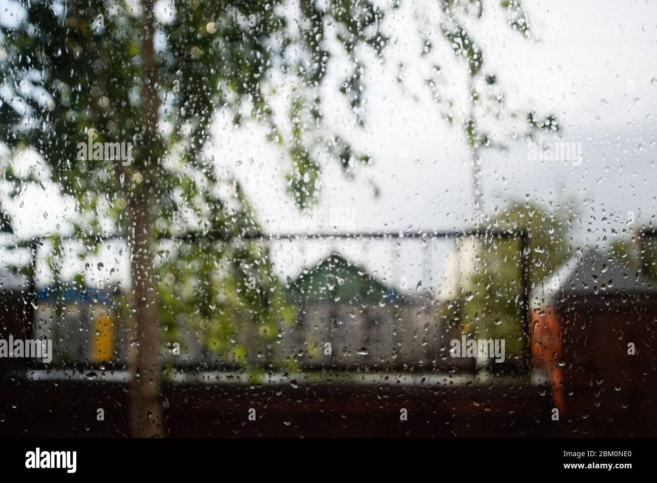 Raindrops on the window pane. Blurred background outside the window in the rain Stock Photo - Alamy