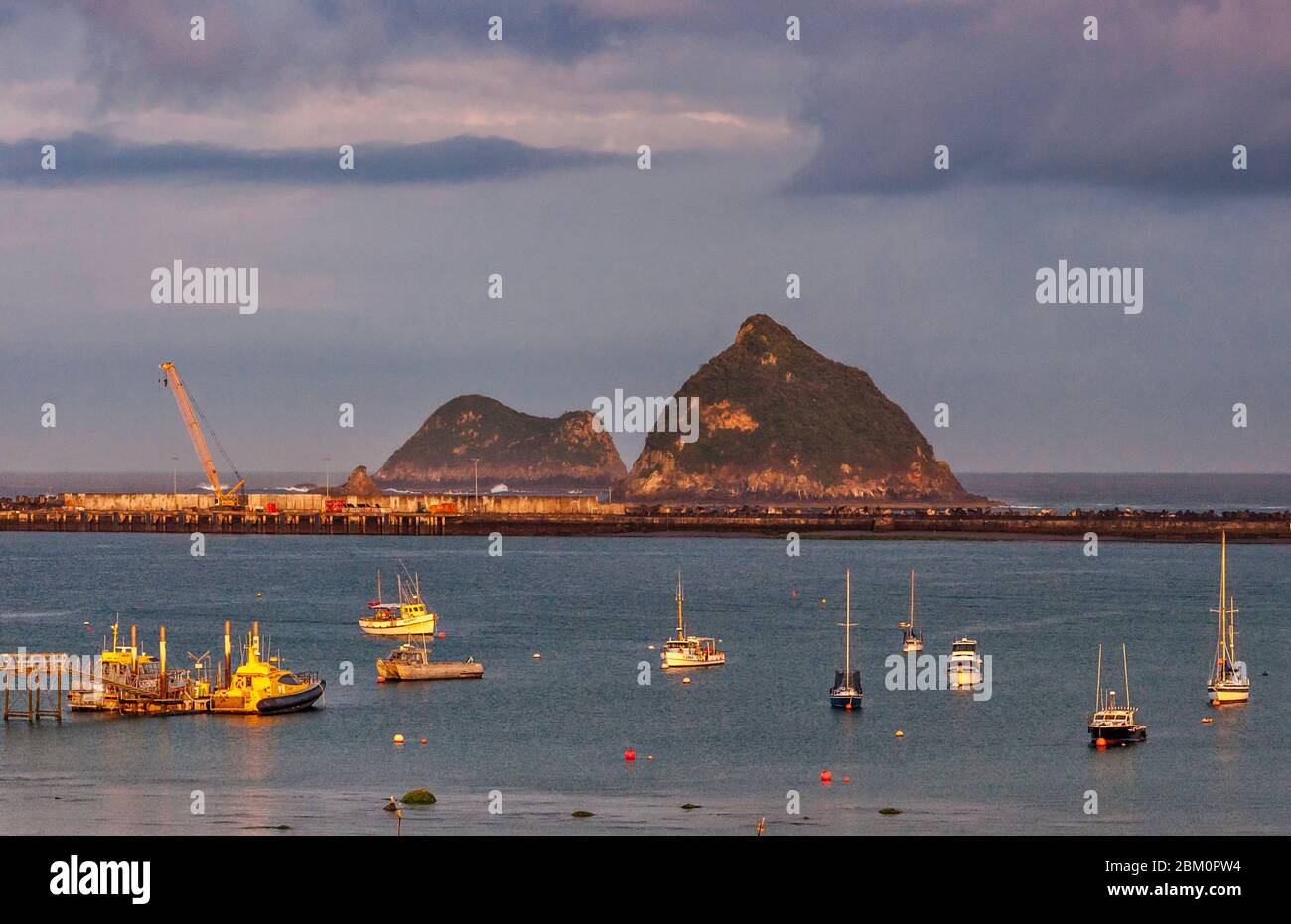 Boats at Port Taranaki, Whareumu and Motorua Islands in dist, sunrise ...