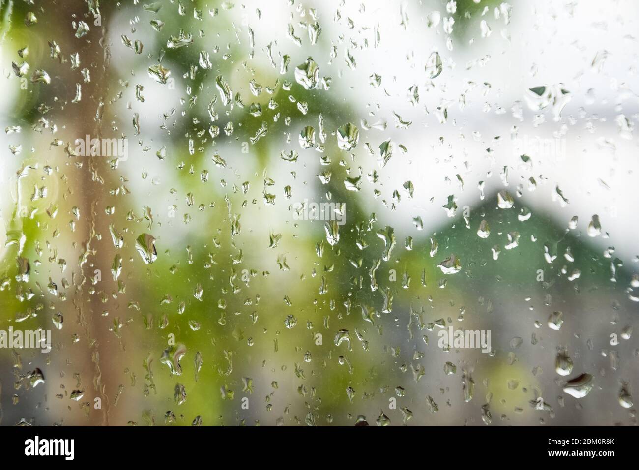 Raindrops on the window pane. Blurred background outside the window in the rain Stock Photo - Alamy