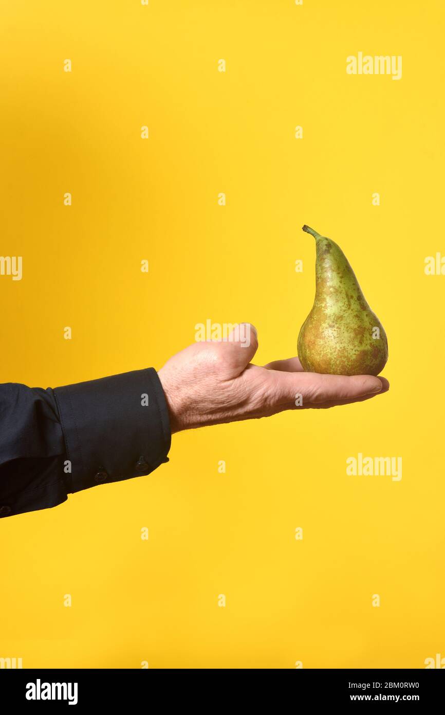 Man hand holding pear hi-res stock photography and images - Alamy