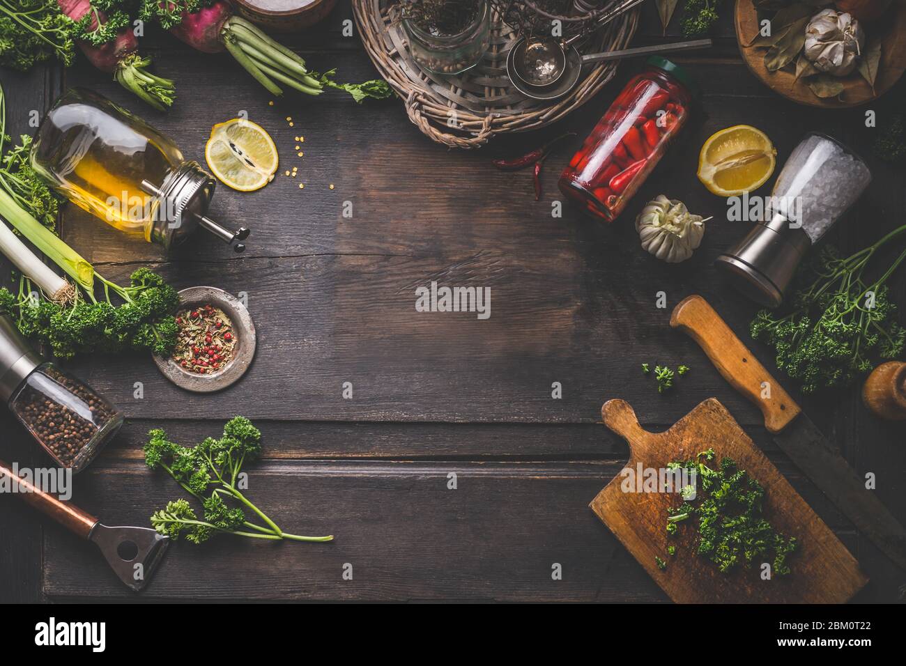 Dark food background with various ingredients and jars with preserved ...