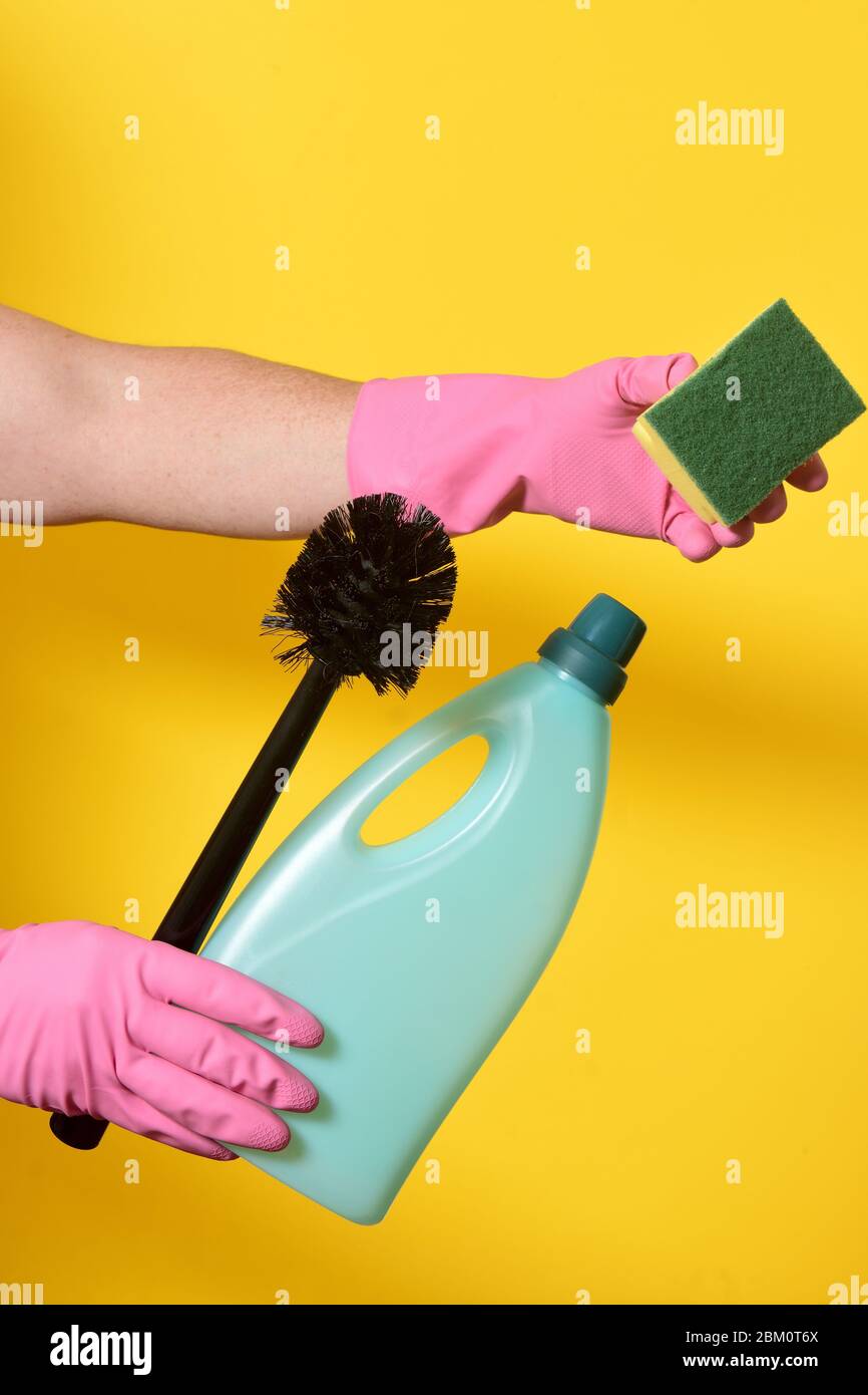 set of cleaning products on yellow background Stock Photo - Alamy