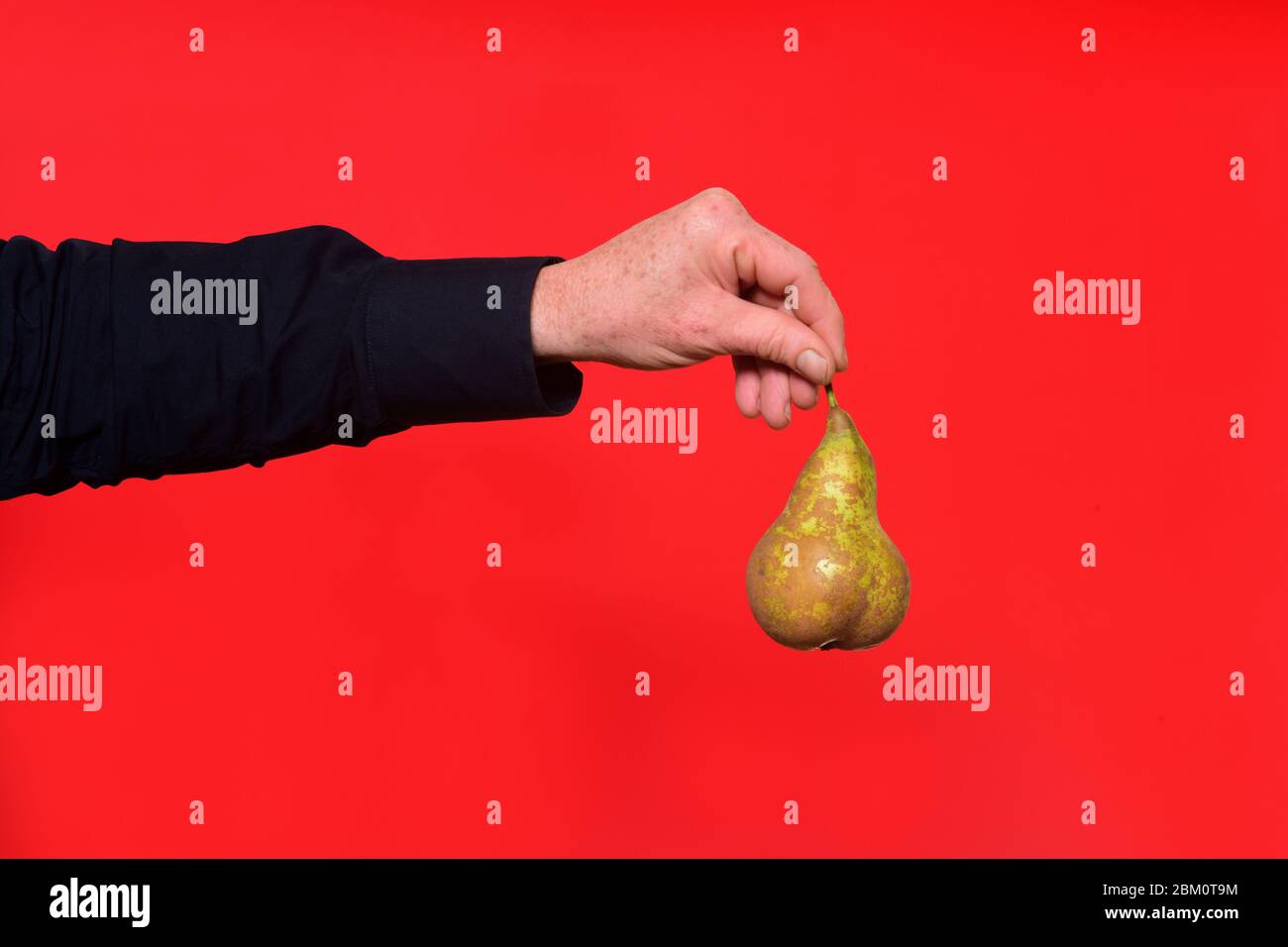 Man hand holding pear hi-res stock photography and images - Alamy