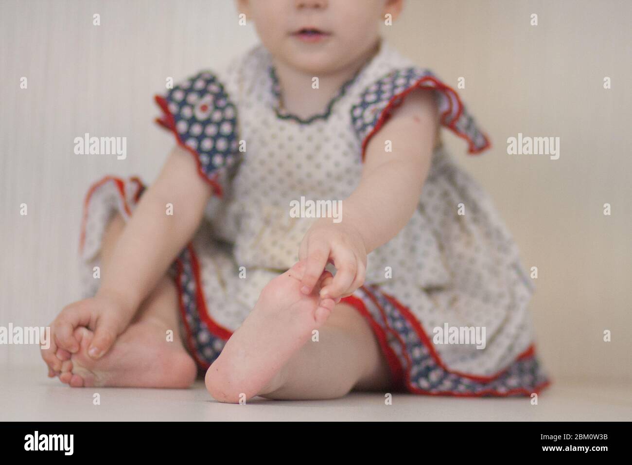 Little girl's knobs. child learns to walk Stock Photo - Alamy