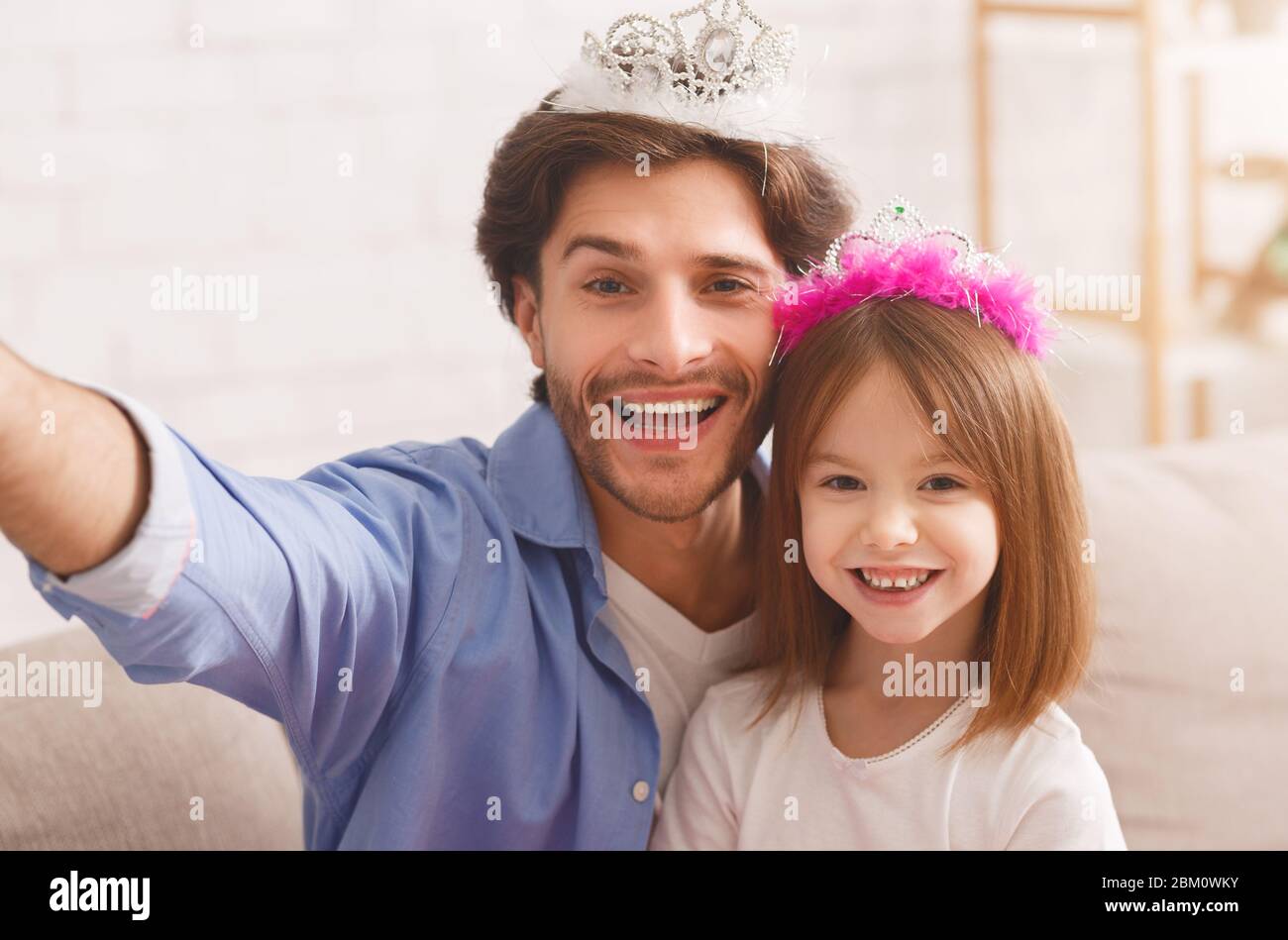 Portrait of pretty little princess and her father wearing crown Stock ...