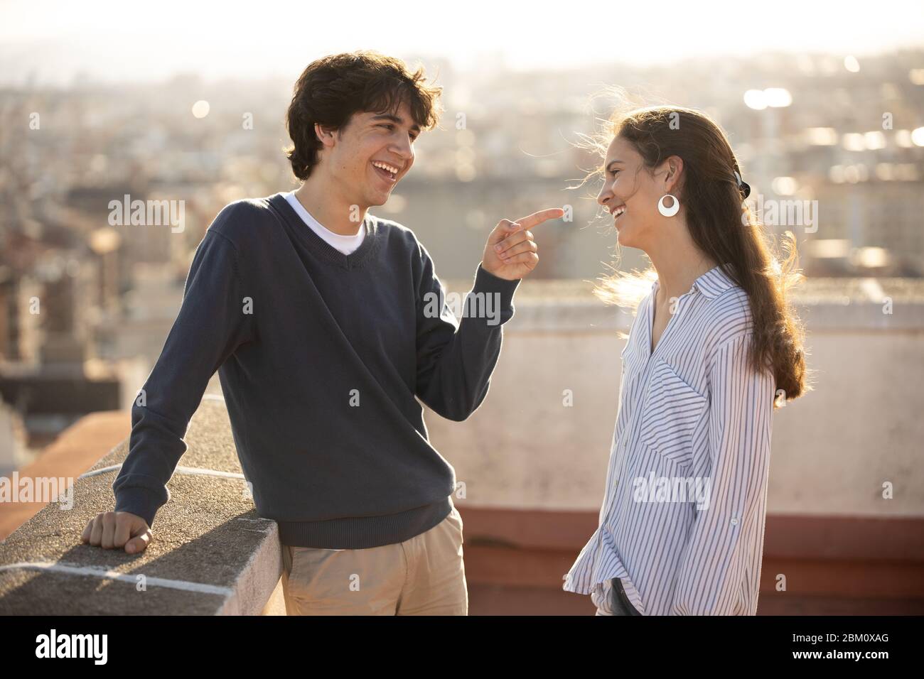 Two young men talking on the rooftop Stock Photo - Alamy