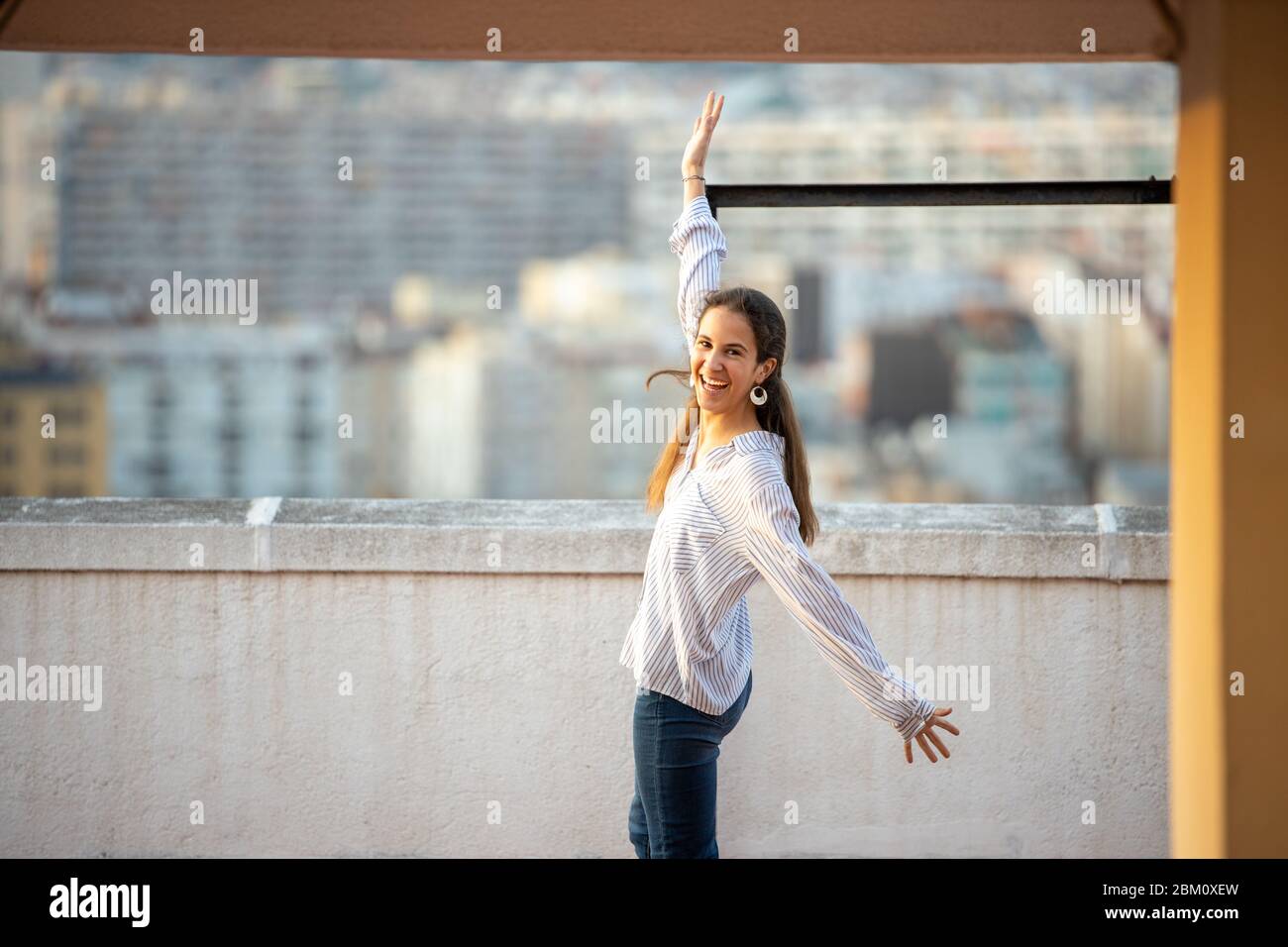 Teen girl dancing on the rooftop Stock Photo - Alamy