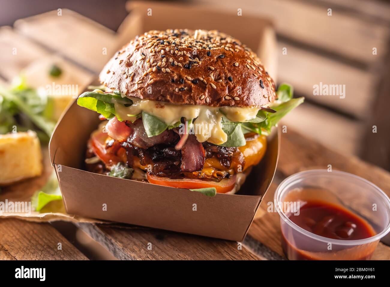 Tasty homemade burger takeaway in a box of recycled paper on wooden ...