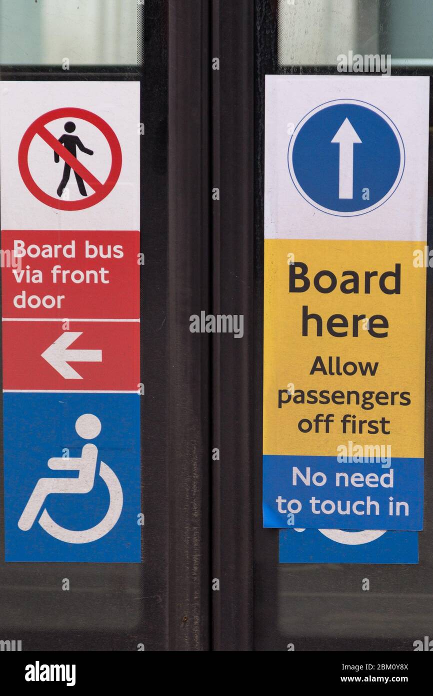 Board here signs on the rear doors of London bus during the coronavirus ...