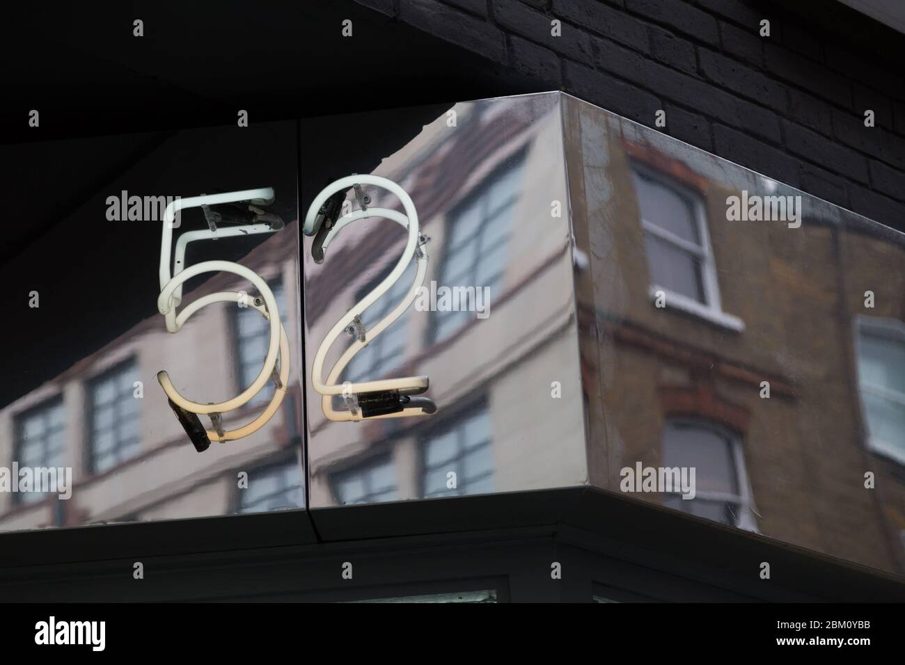 Neon number 52 (fifty-two) on a mirrored background Stock Photo - Alamy