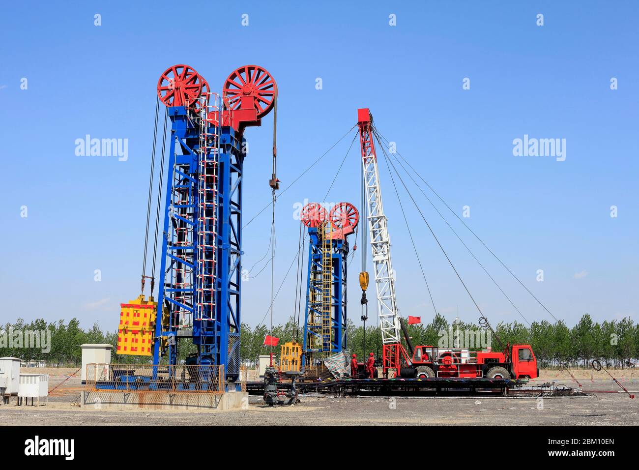 In oilfield, the workers in hard work Stock Photo - Alamy