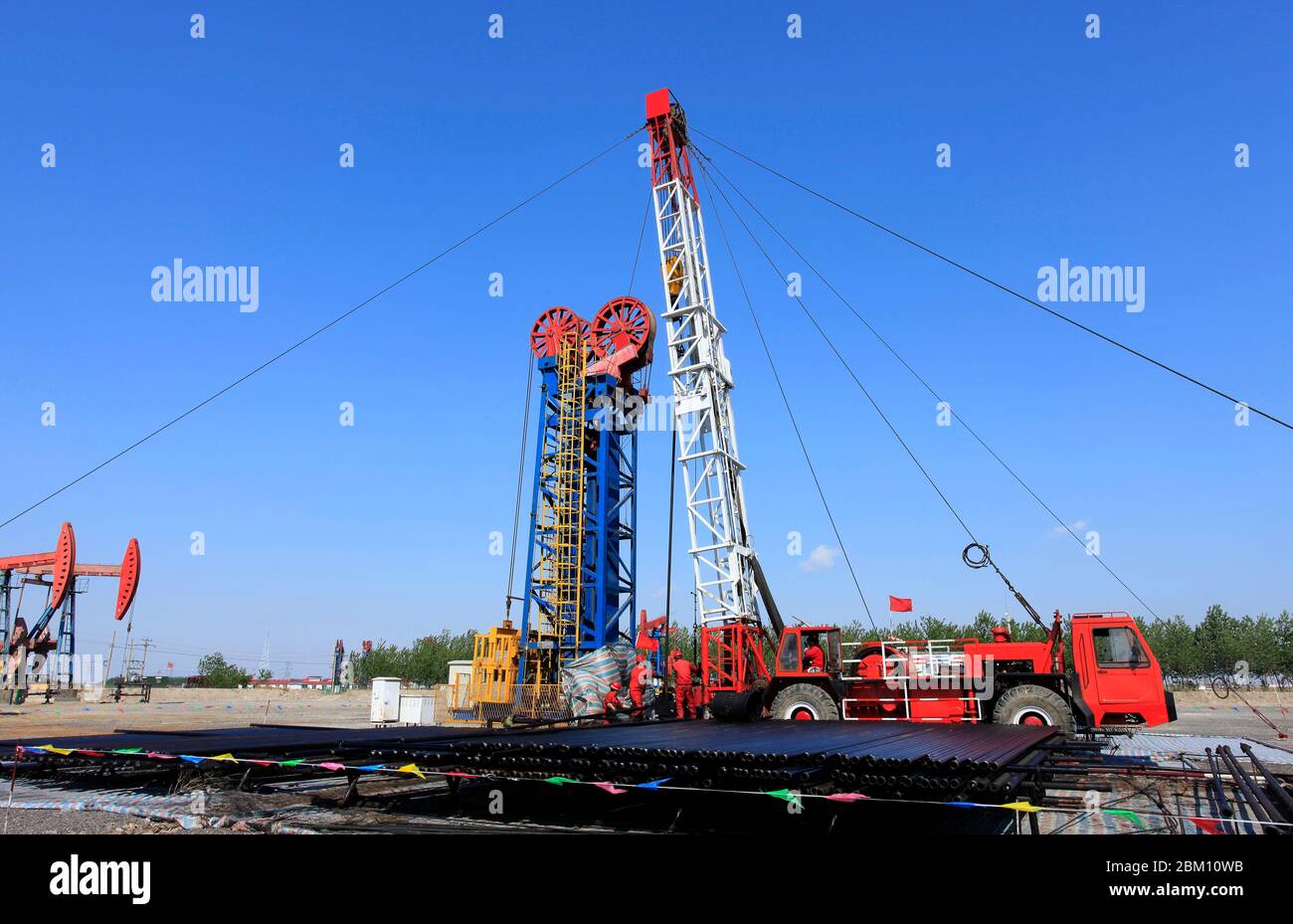 In oilfield, the workers in hard work Stock Photo - Alamy