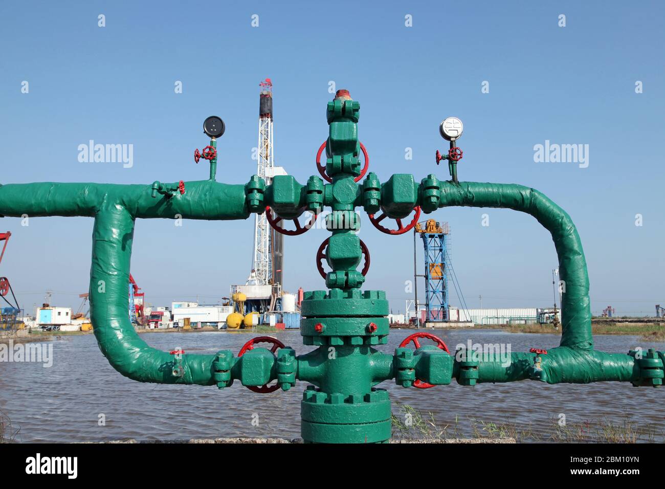 Piping and valves of oil field, close-up Stock Photo - Alamy