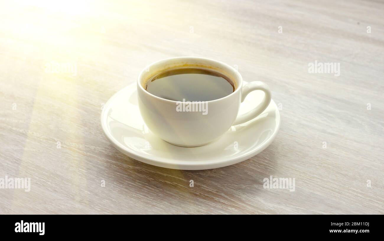 Morning coffee black hot espresso with steam in white cup, saucer on ...
