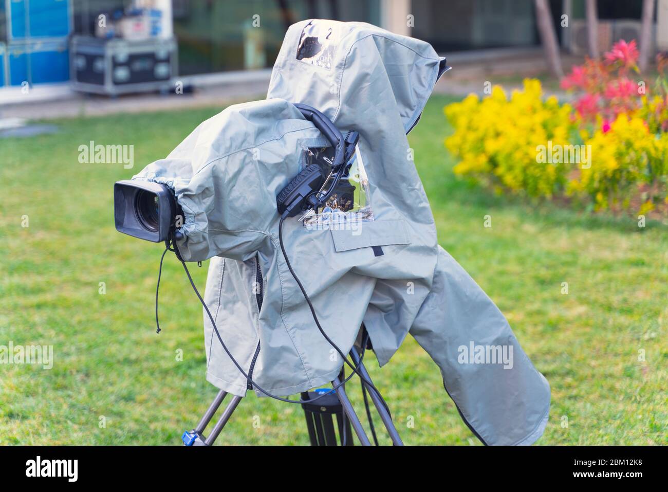 Television broadcast camera setup on a tripod and protected by a rain ...