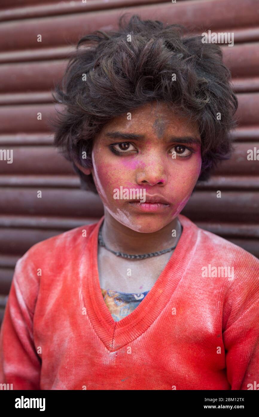 A portrait of small boy on a day of festival of colours in Vrindavan ...