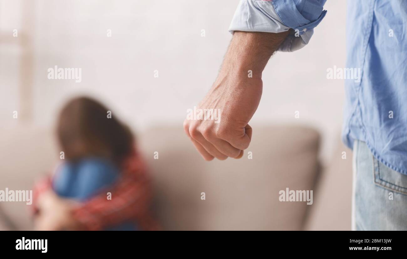 Cropped of man clenching fist, crying little girl on background Stock ...