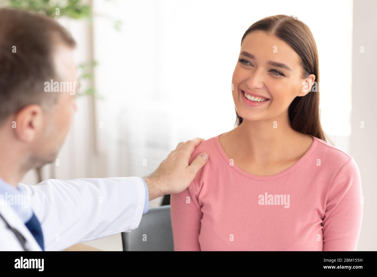 Patient receiving medical consultation and looking at doctor Stock ...