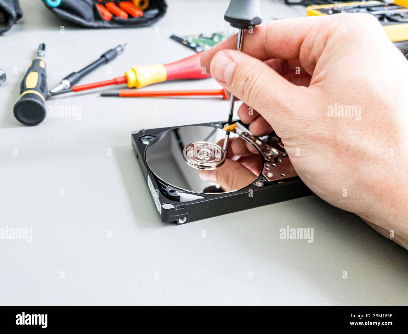 Repairing malfunctioned computer hard drive - removing screws and ...