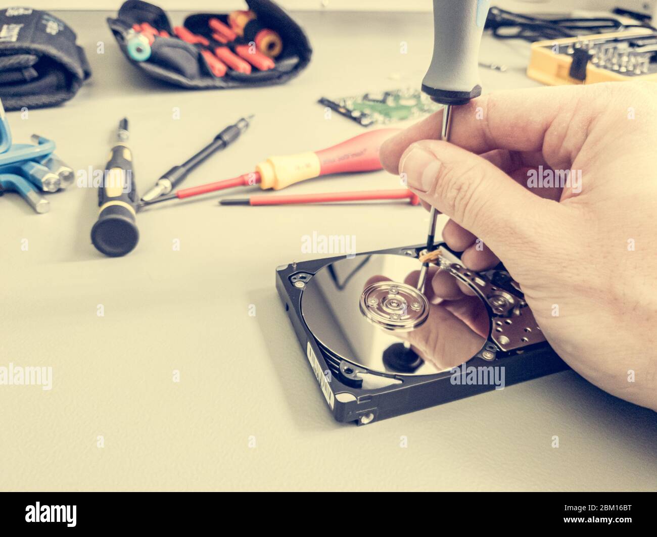 Repairing malfunctioned computer hard drive - removing screws and ...