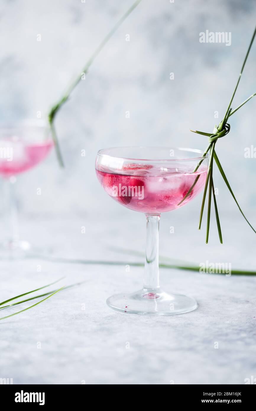 Pink mocktail close up. Beverage with rose and prosecco wine in ...