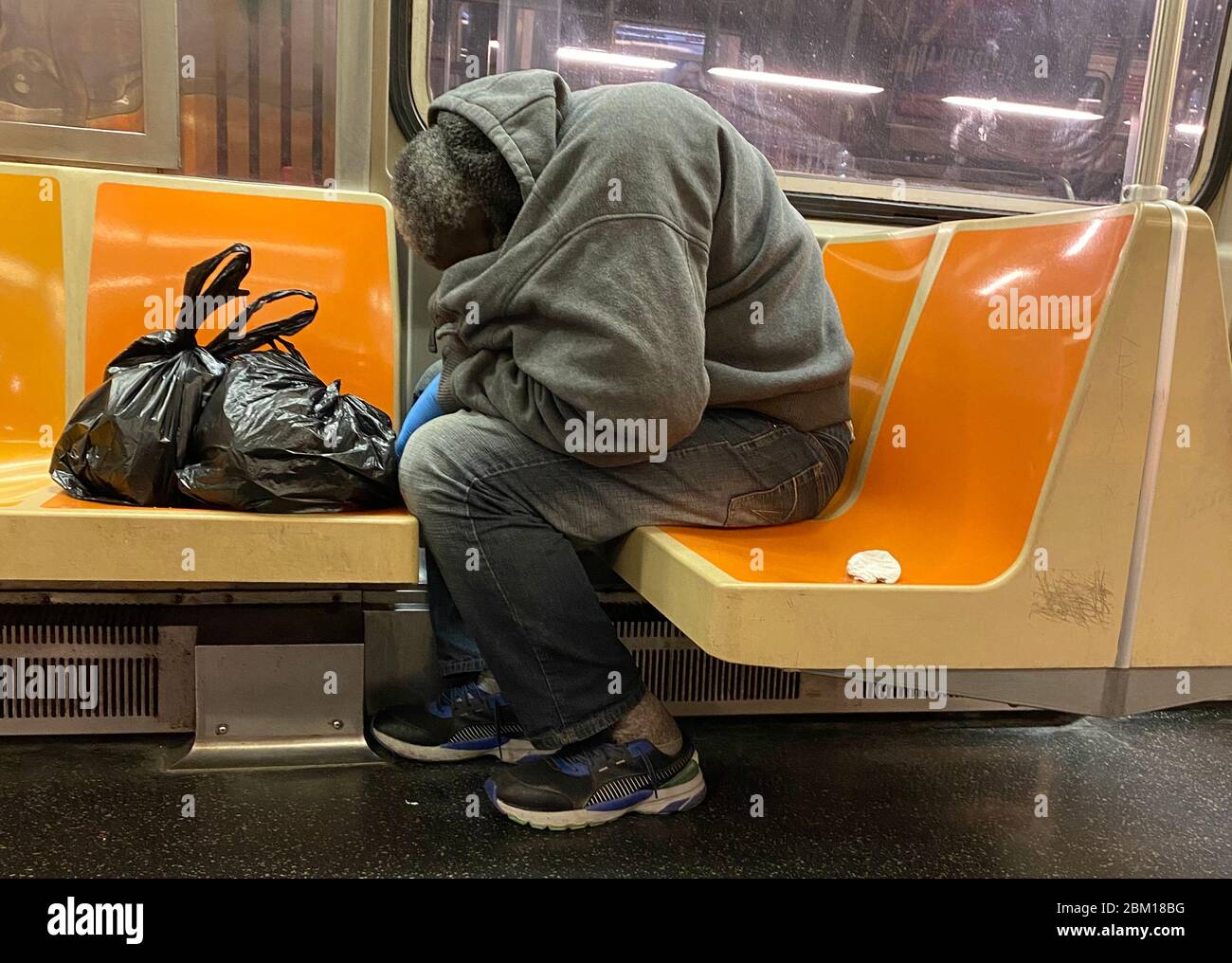 Homeless man sleeping in subway hi-res stock photography and images - Alamy