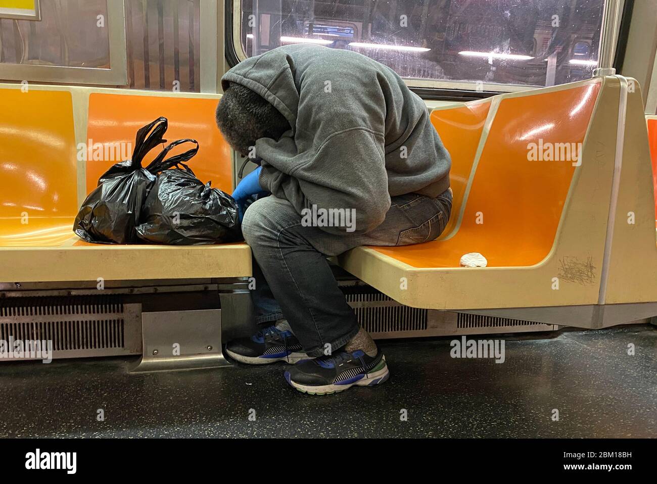 Homeless man sleeping in subway hi-res stock photography and images - Alamy