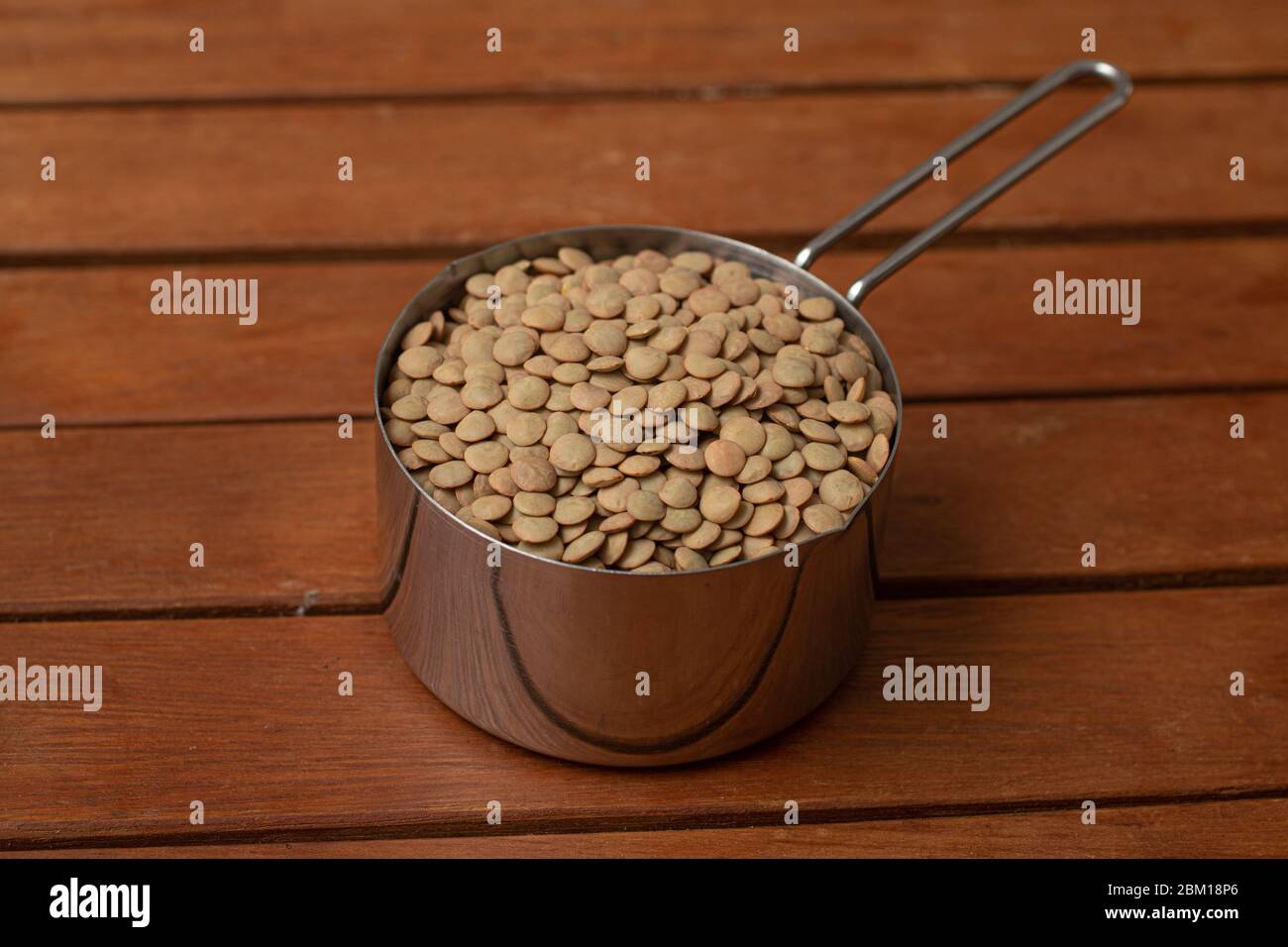 Pile of raw lentil in a Cup isolated on white background Stock Photo ...
