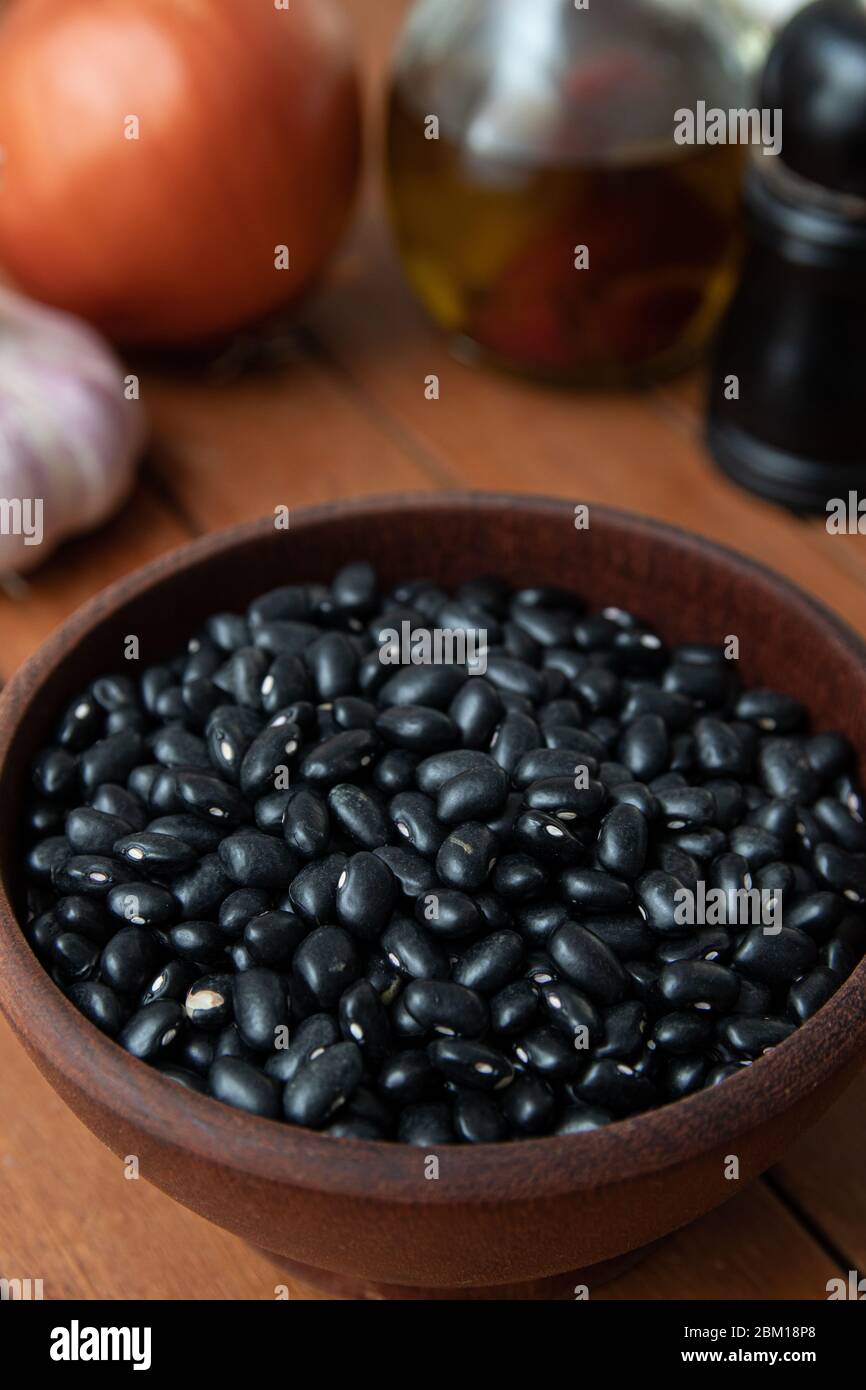 Pile of raw Brazilian Black Beans in a bowl. Also know as 'Feijao' over ...