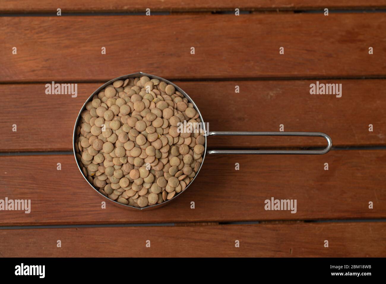 Pile of raw lentil in a Cup isolated on white background Stock Photo - Alamy