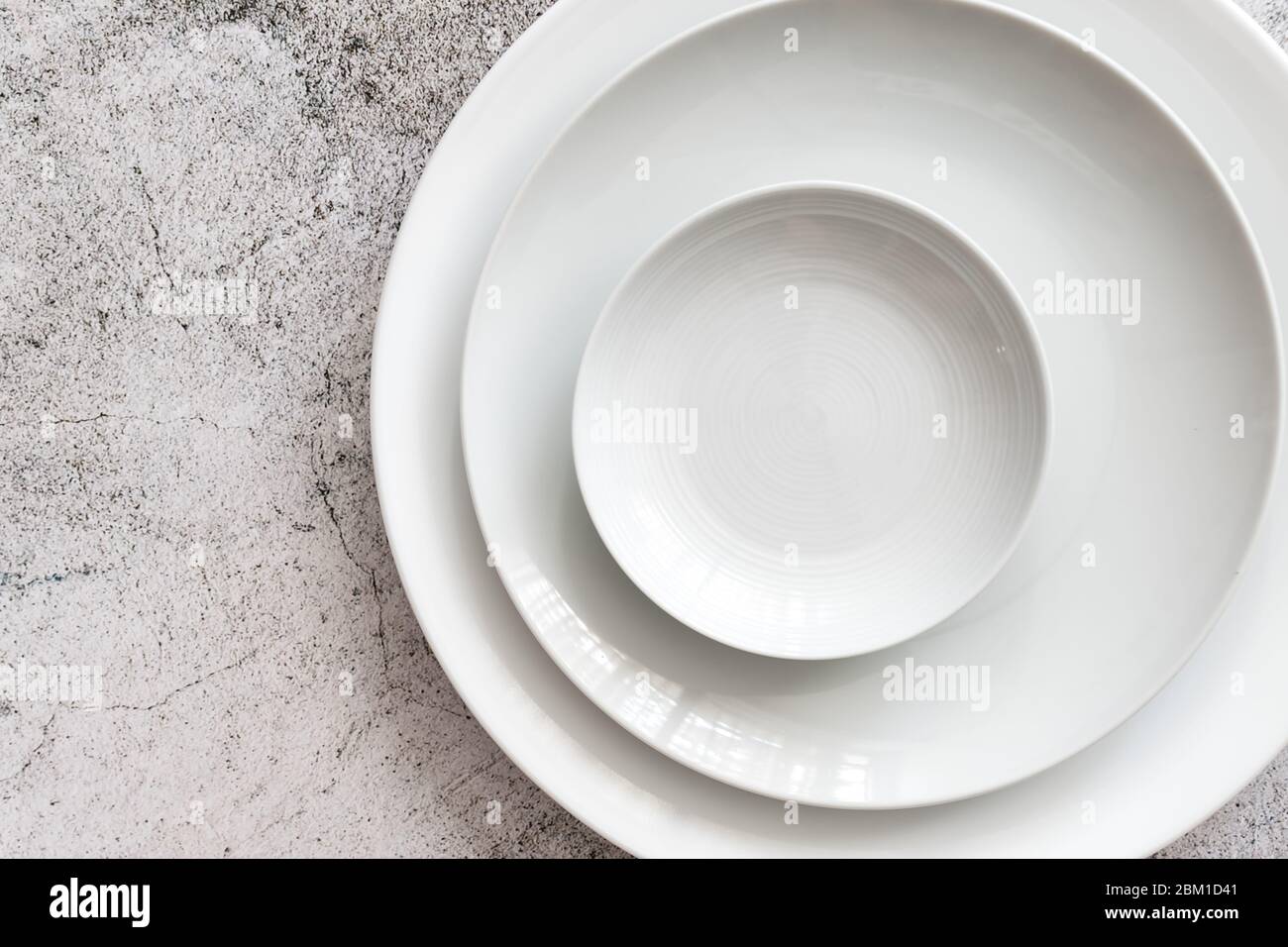 white color Plain dinner plate on stone table Stock Photo - Alamy