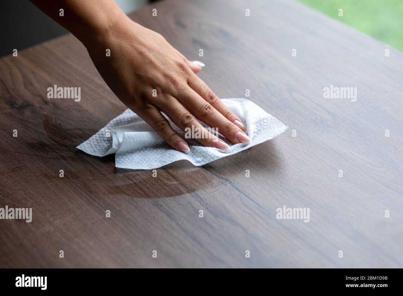 Woman's hand cleaning home office table surface with wet wipes Stock ...