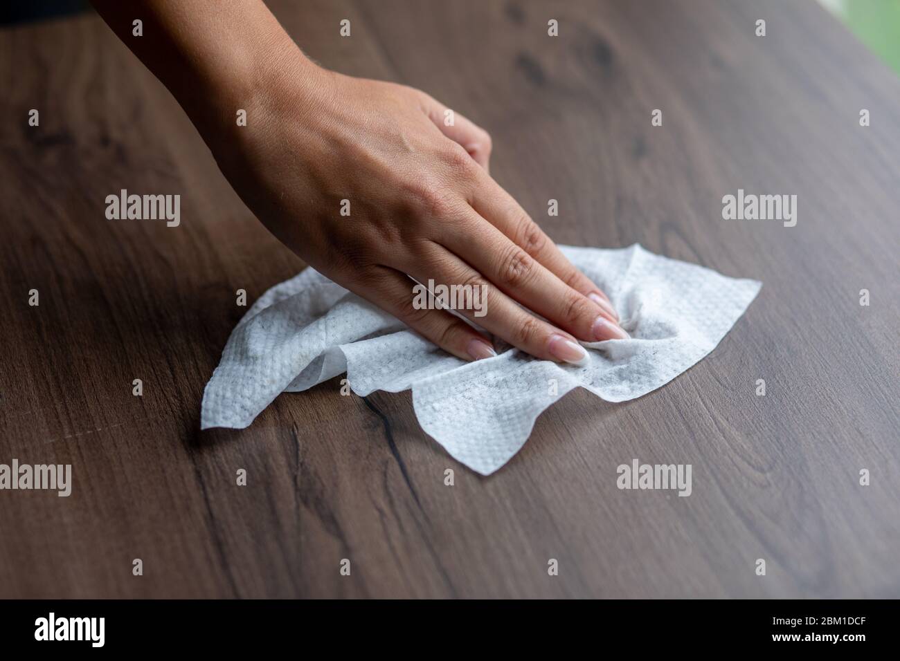 Woman's hand cleaning home office table surface with wet wipes Stock ...