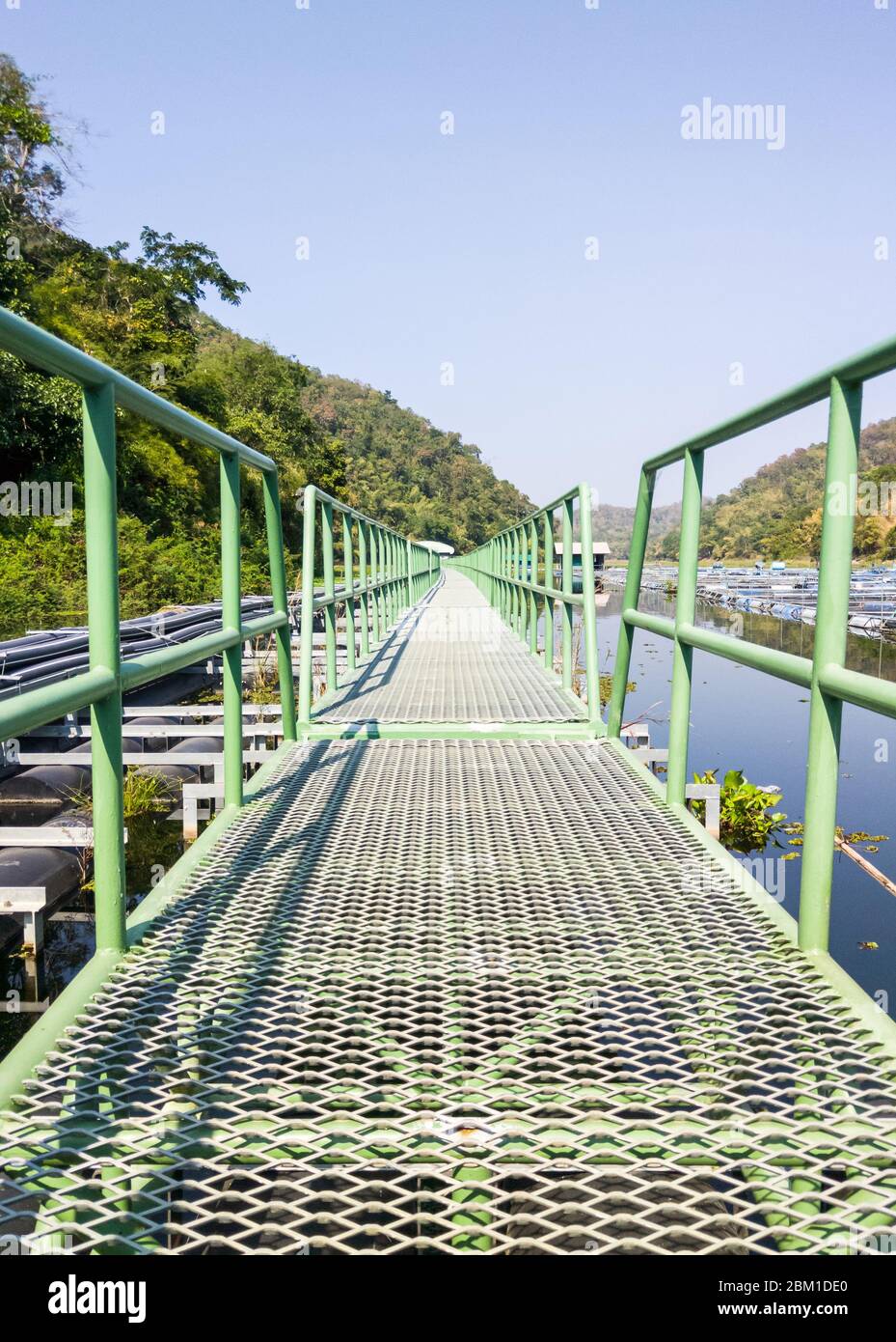 Long metal bridge is floating on the reservoir for use to walk to the ...