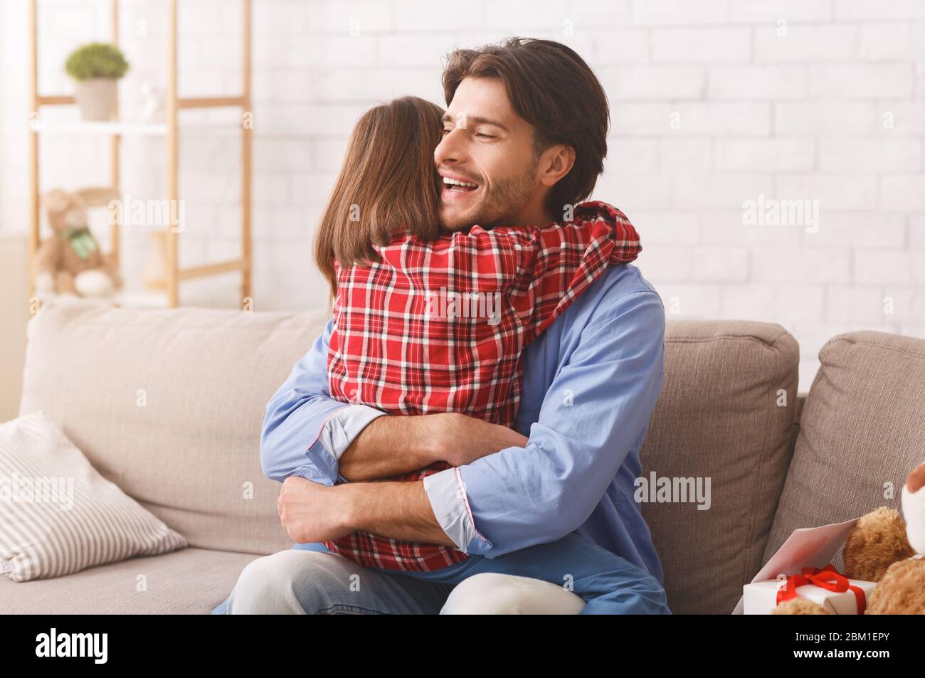 Emotional dad hugging daughter, thankful for greeting Stock Photo - Alamy