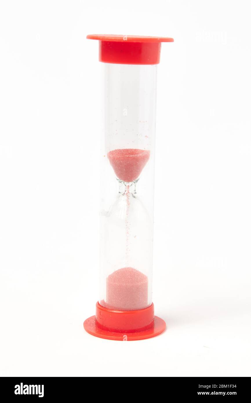 red hourglass on a white background isolate Stock Photo - Alamy