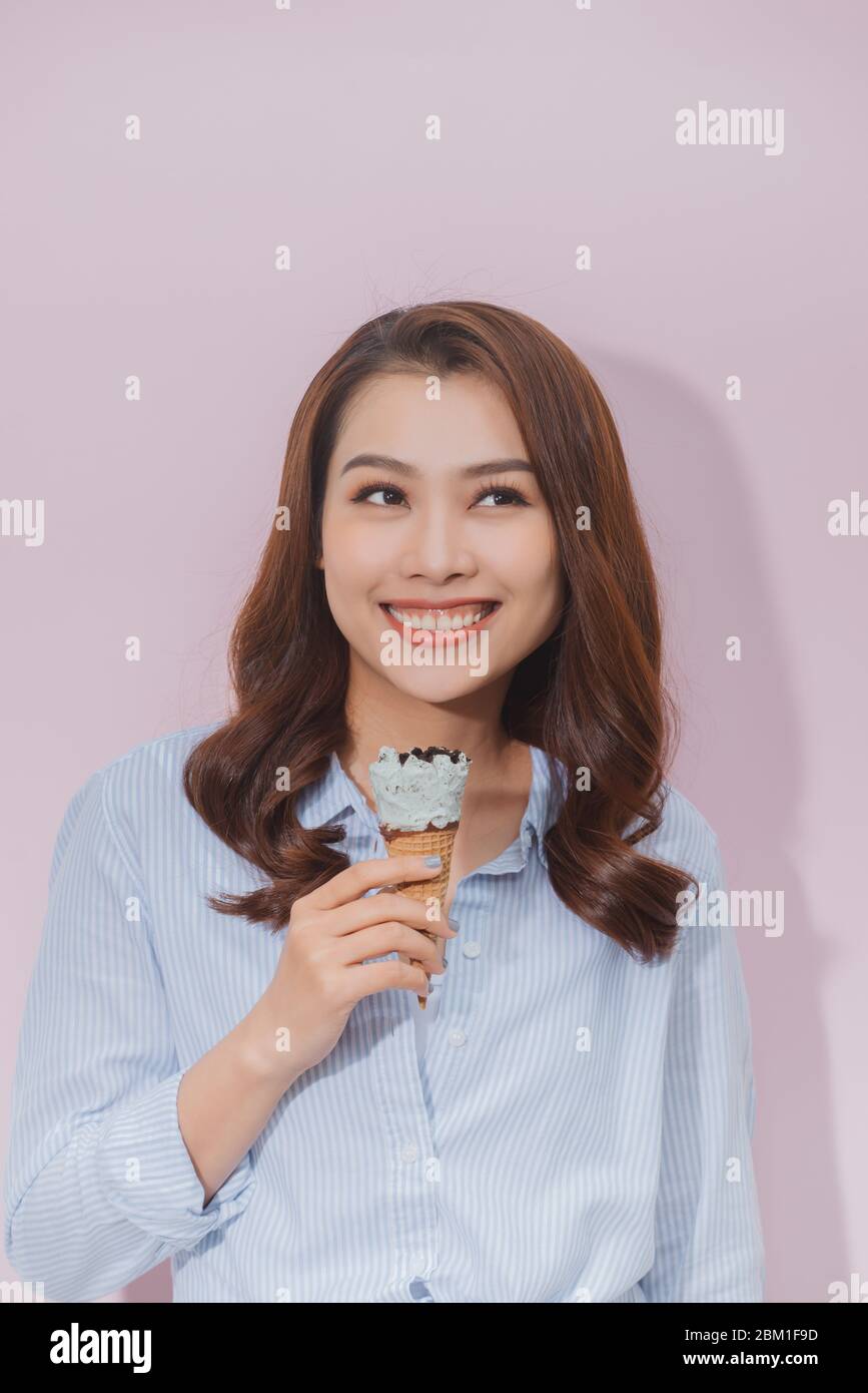 Pretty Asian girl eating junk food by not diet or loss weight concept ...