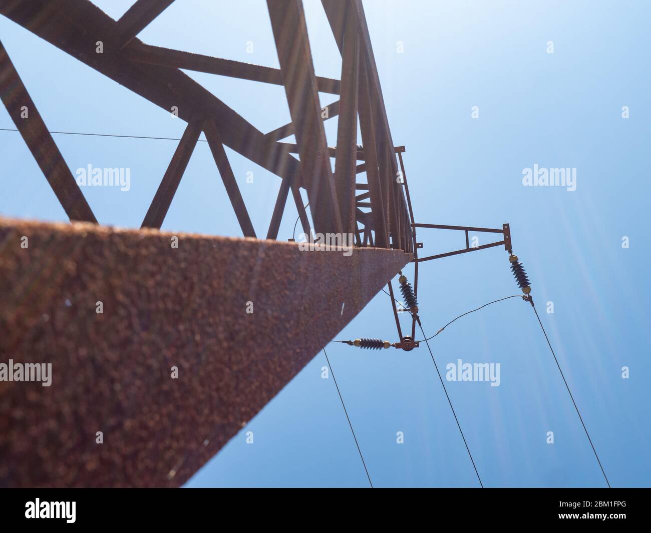 Rusty pole. Steel rusty construction of an energy pole standing in a ...