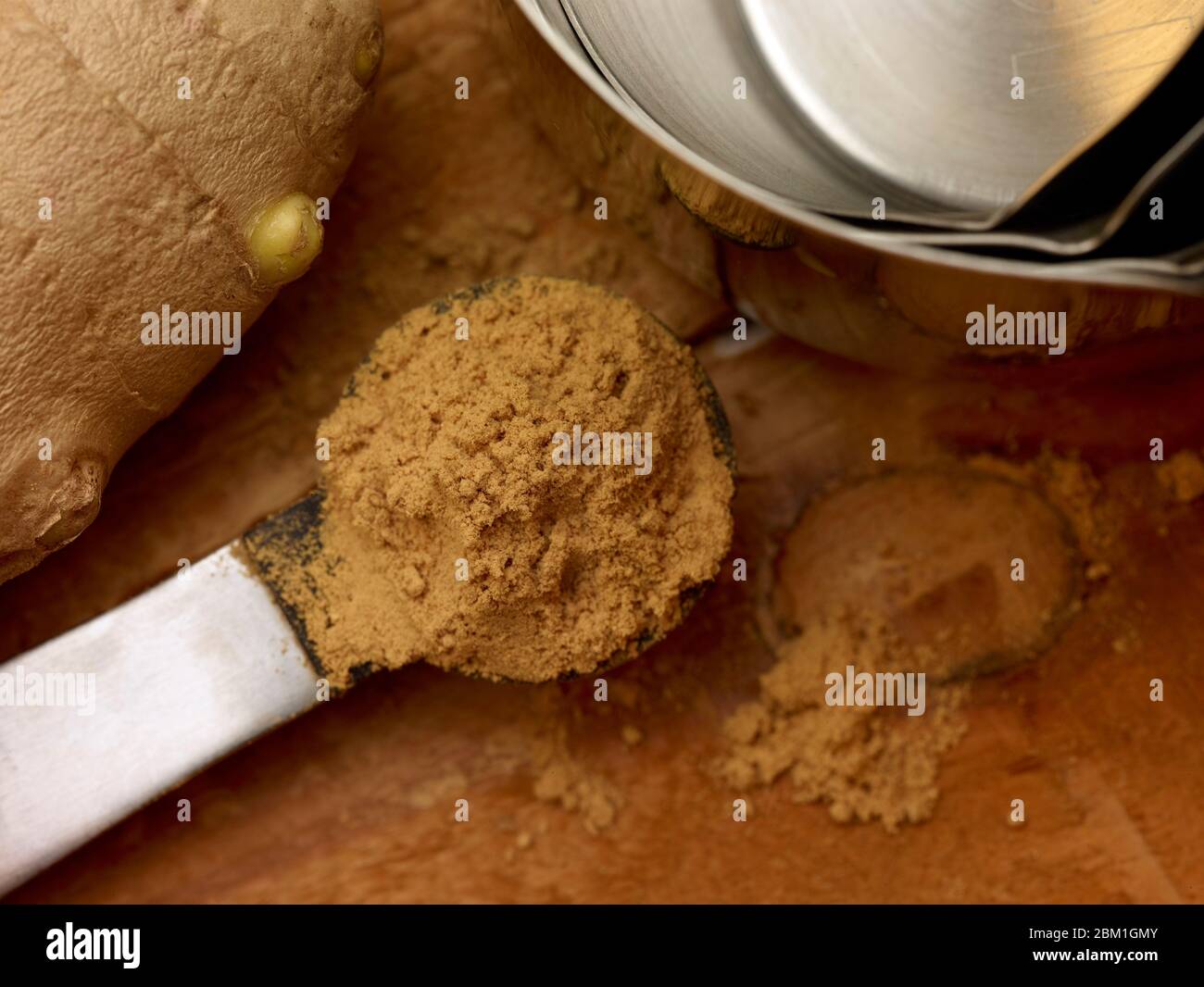Close-up still life of ground ginger in measuring spoon, food ...