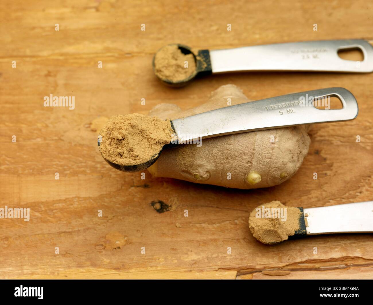 Close-up still life of ground ginger in measuring spoon, food ...