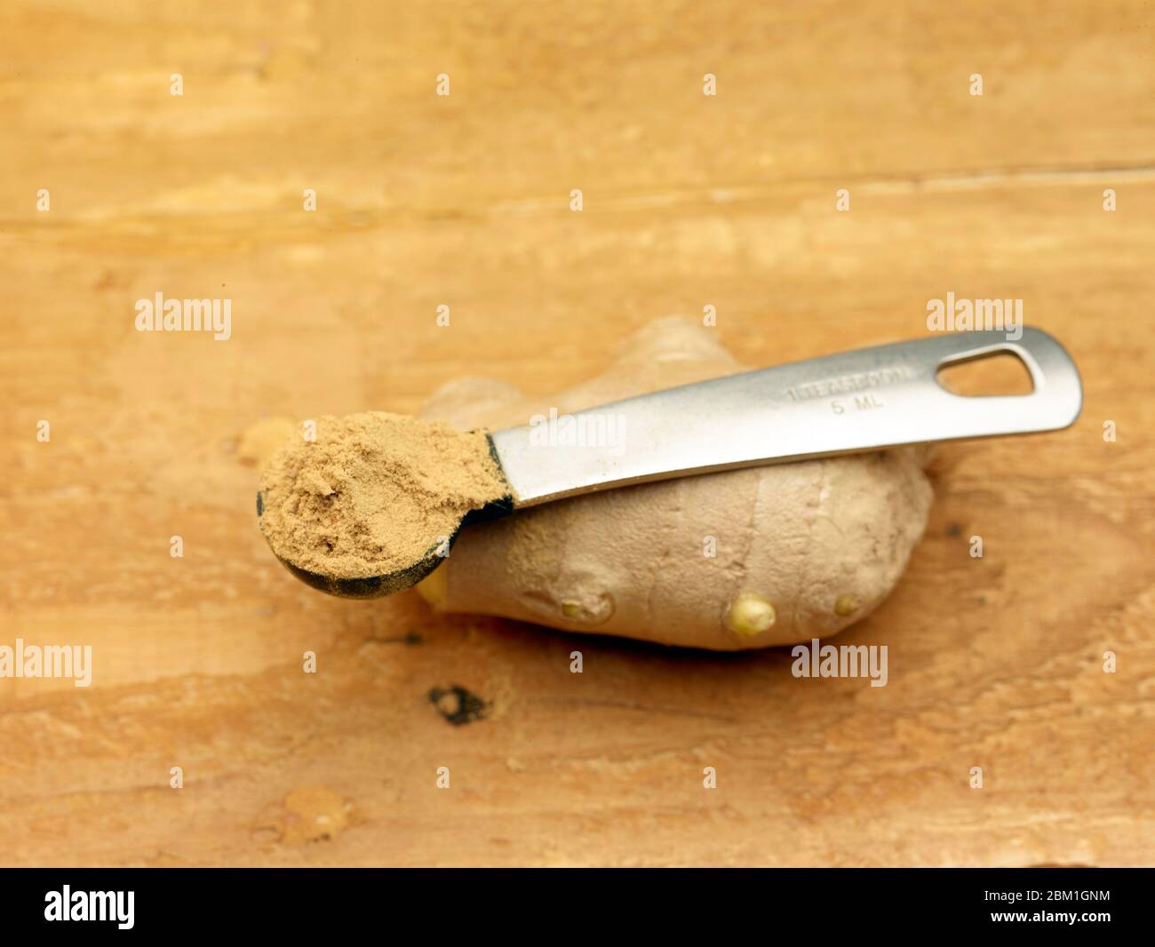Close-up still life of ground ginger in measuring spoon, food ...