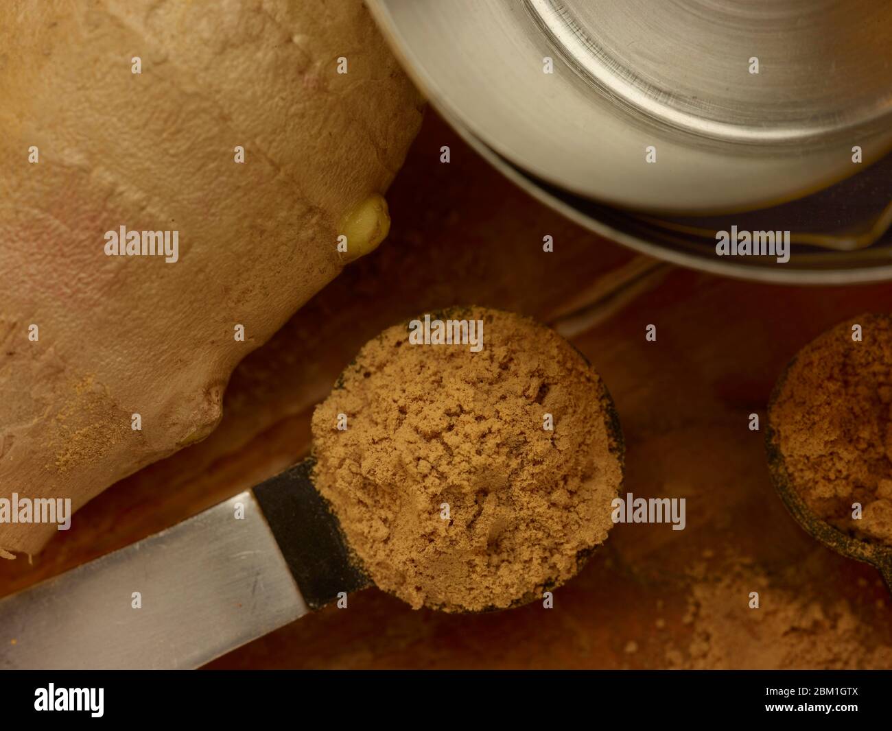 Close-up still life of ground ginger in measuring spoon, food ...