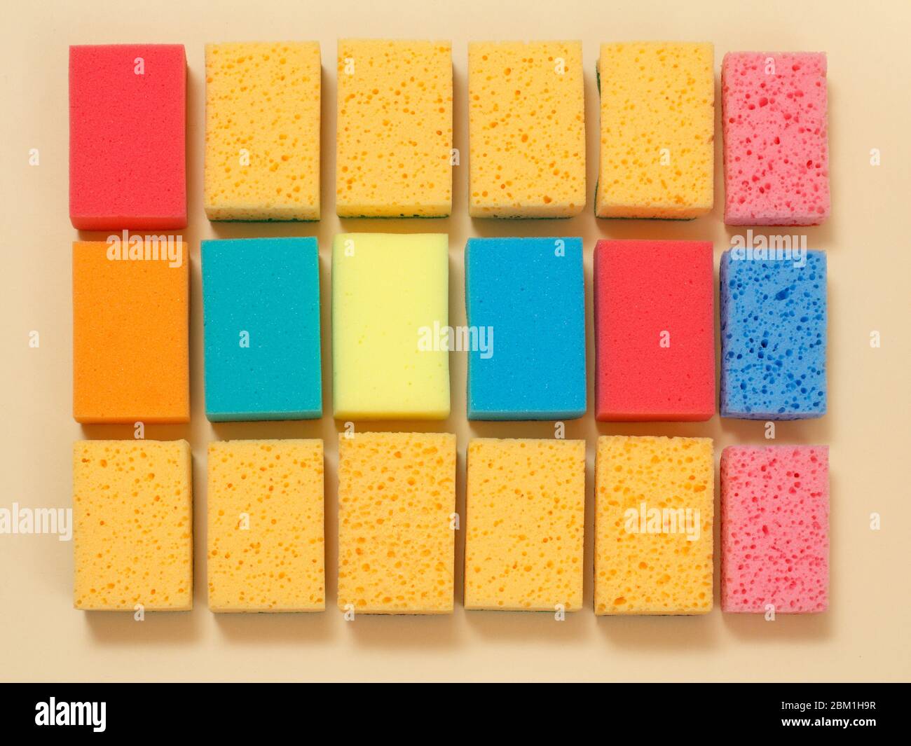 Sponges of different colors on a beige background. Top view. Washing ...