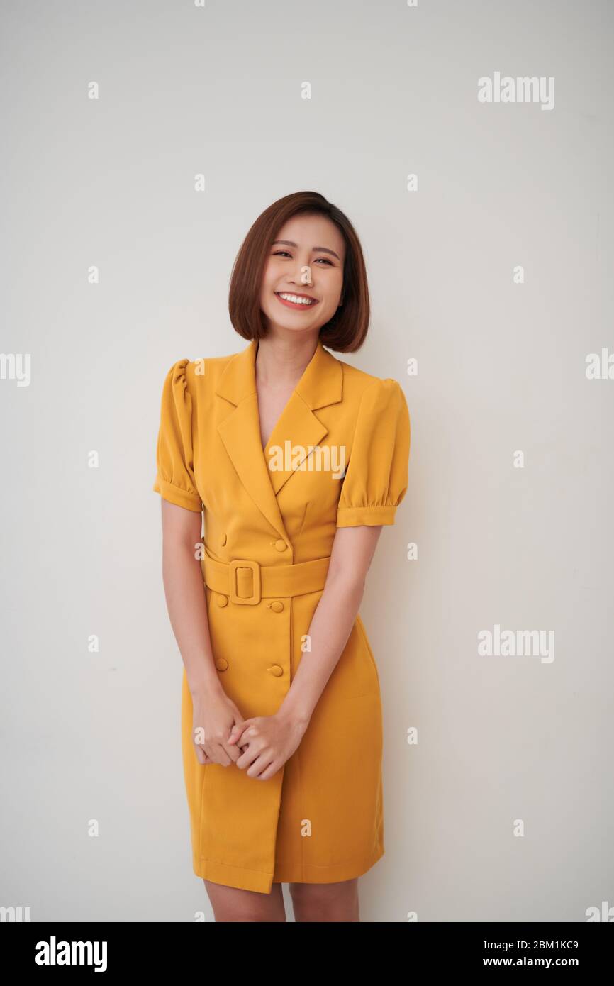 Smiling gorgeous woman wearing classy clothes posing on white ...