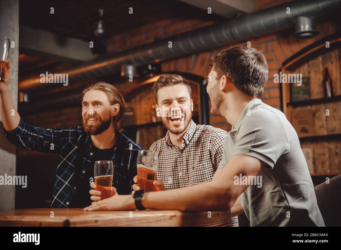 Funny old friends gathered bar to have beer and watch match of your ...