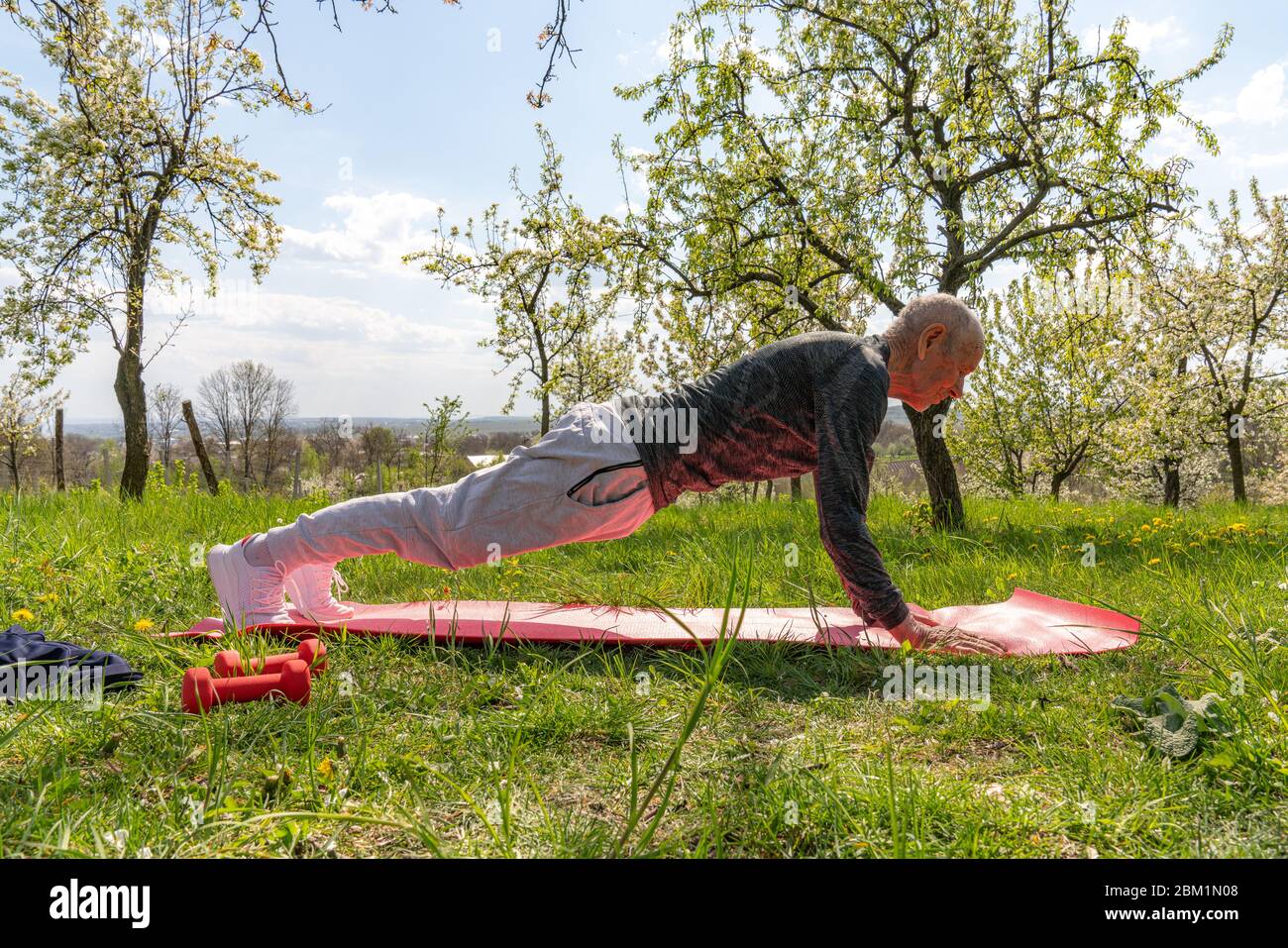 Full body of old sportsman doing plank on stadium. Profile of man in ...