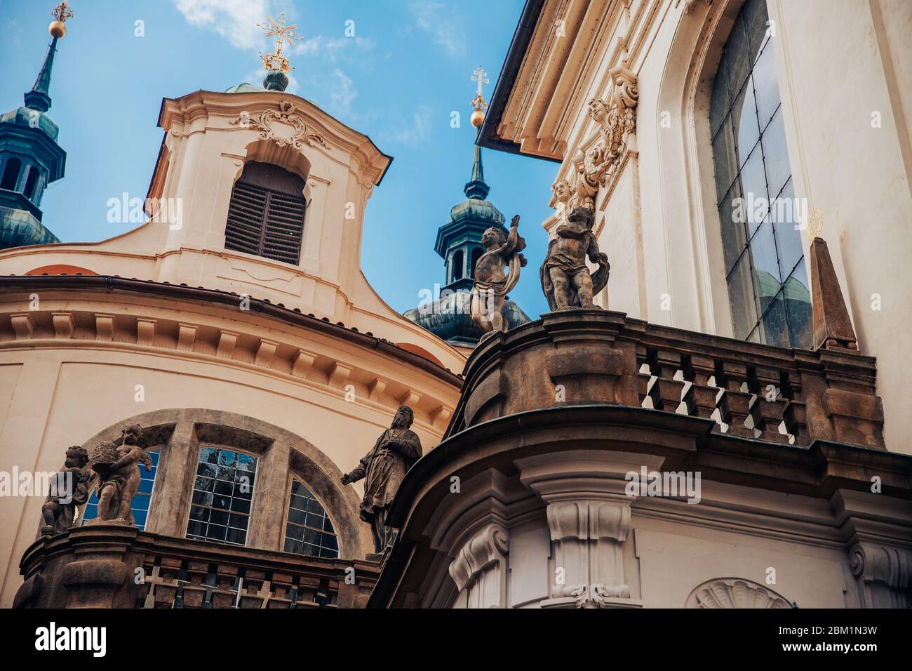 Close-up Two towers green oxidized rusty roofs overlook Church pediment ...
